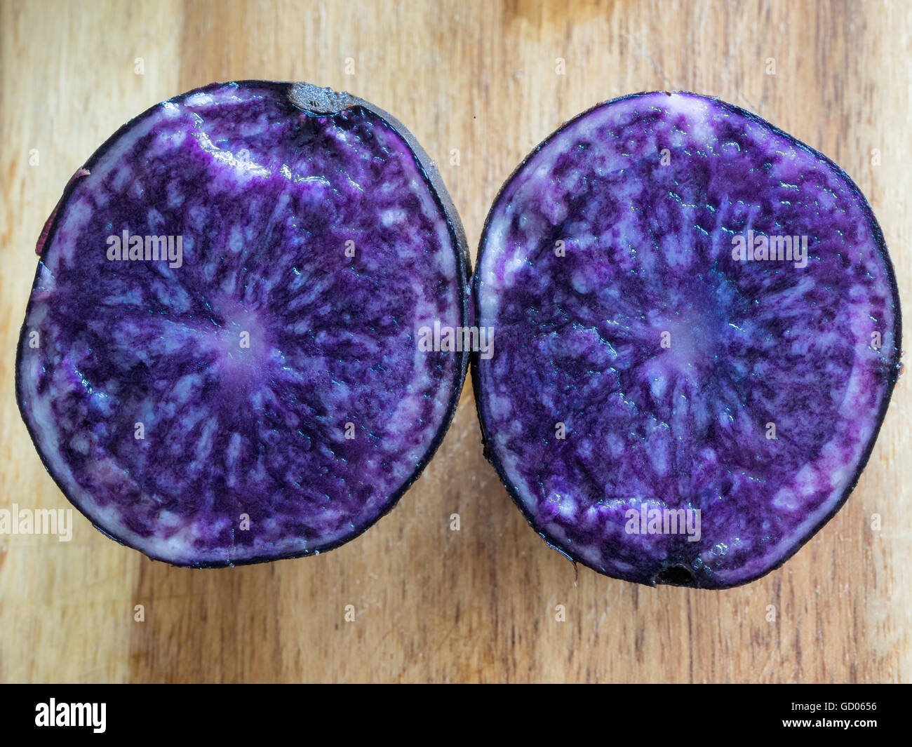 Blue potatoes cut in halves fresh from the garden Stock Photo - Alamy