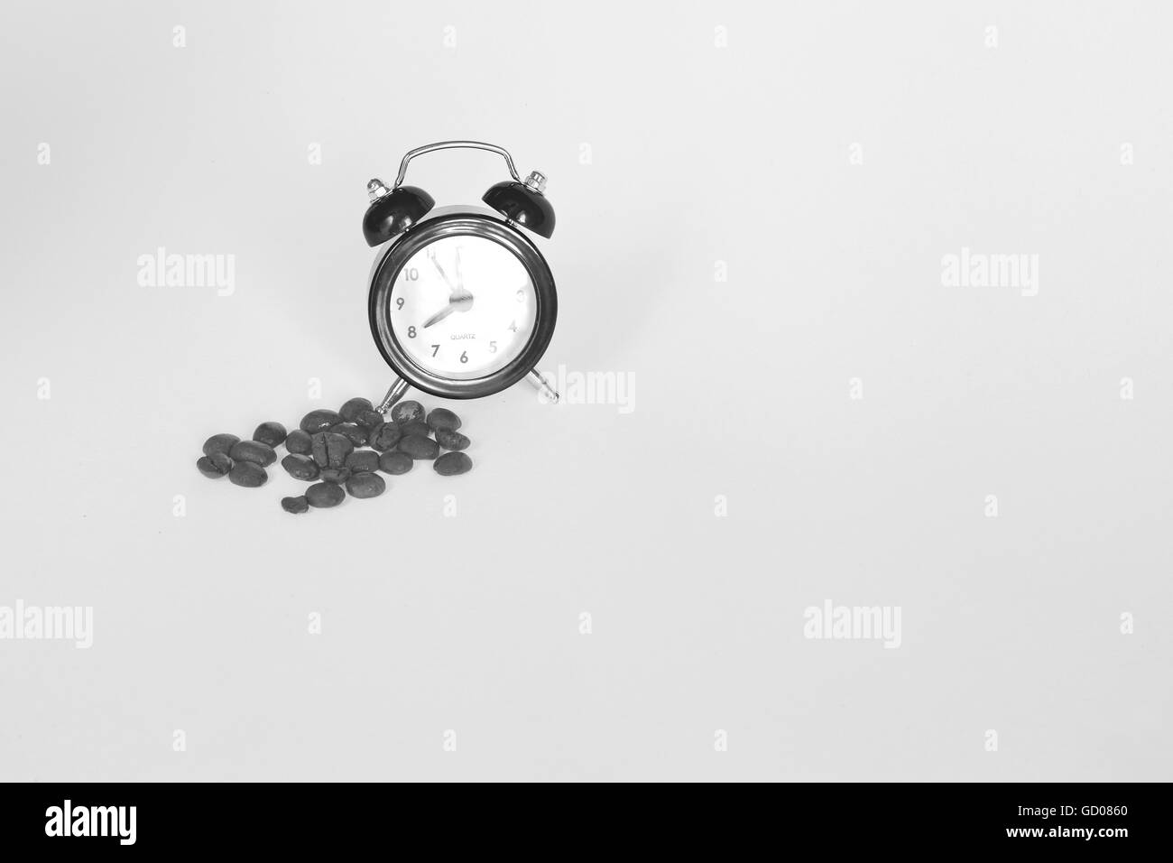 Alarm clock (with reflection) and coffee beans on background Stock ...