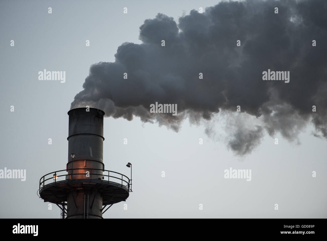 Oil Refinery or Petrochemical plant chimneys at dusk Stock Photo - Alamy
