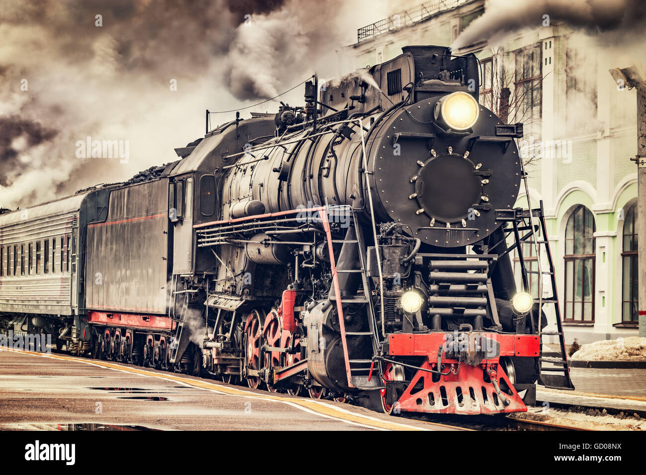 Retro steam train departs from the station Stock Photo - Alamy