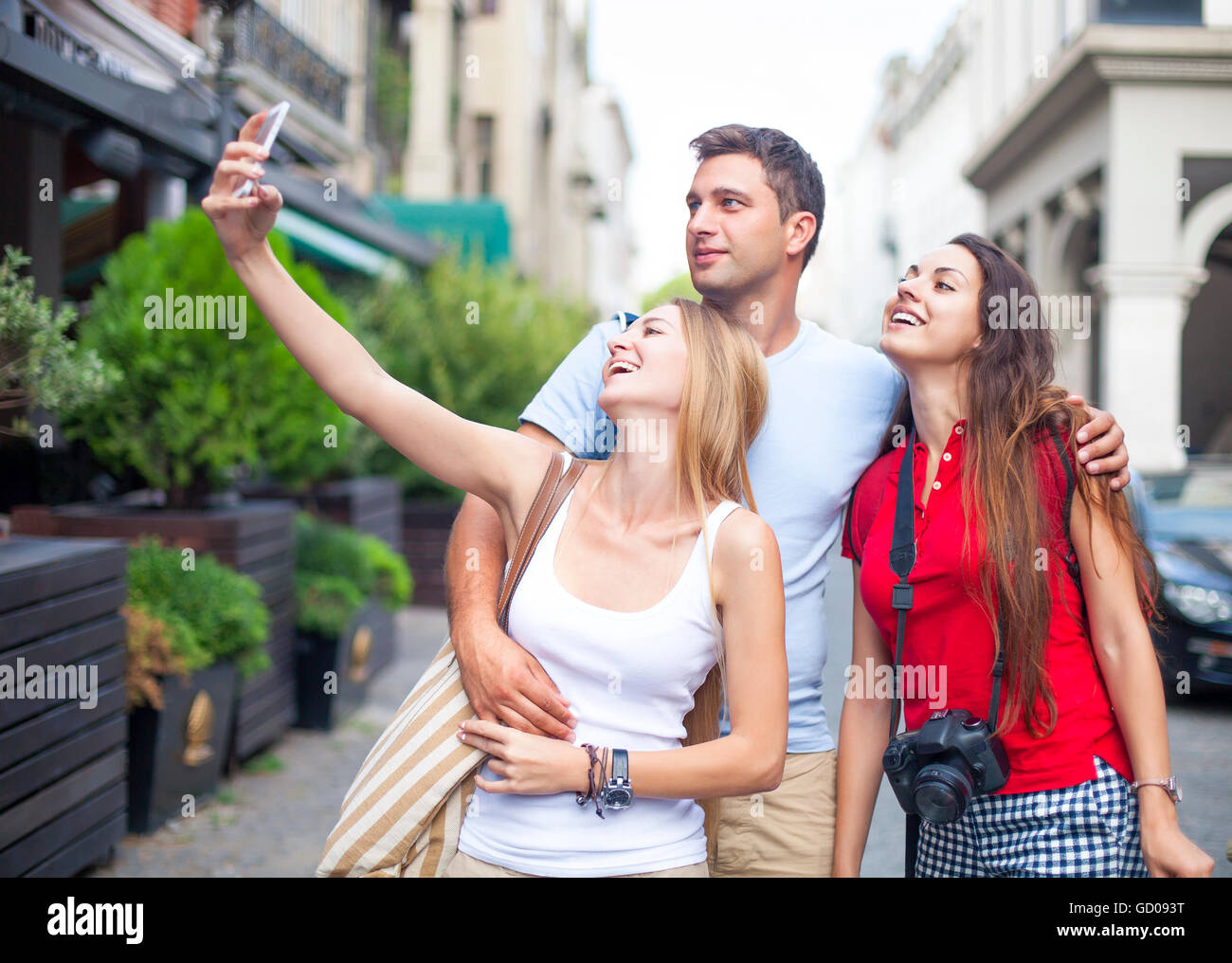 Group of happy tourists friends laughing and taking a selfie in the ...