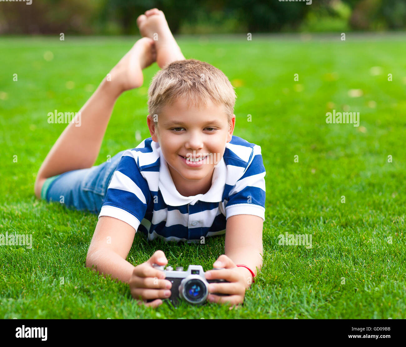 Happy smiling little boy with retro vintage camera in summer park Stock ...