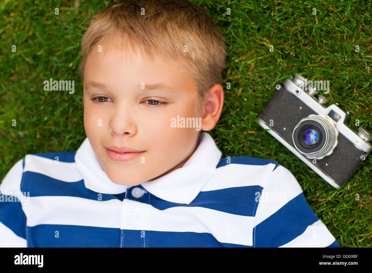 Happy smiling little boy with retro vintage camera in summer park Stock ...