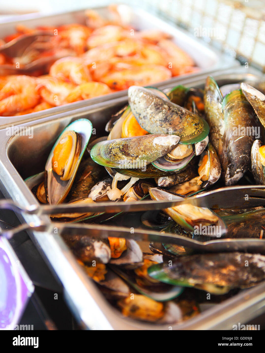 Buffet table with seafood with shrimps, fried calamari rings and ...