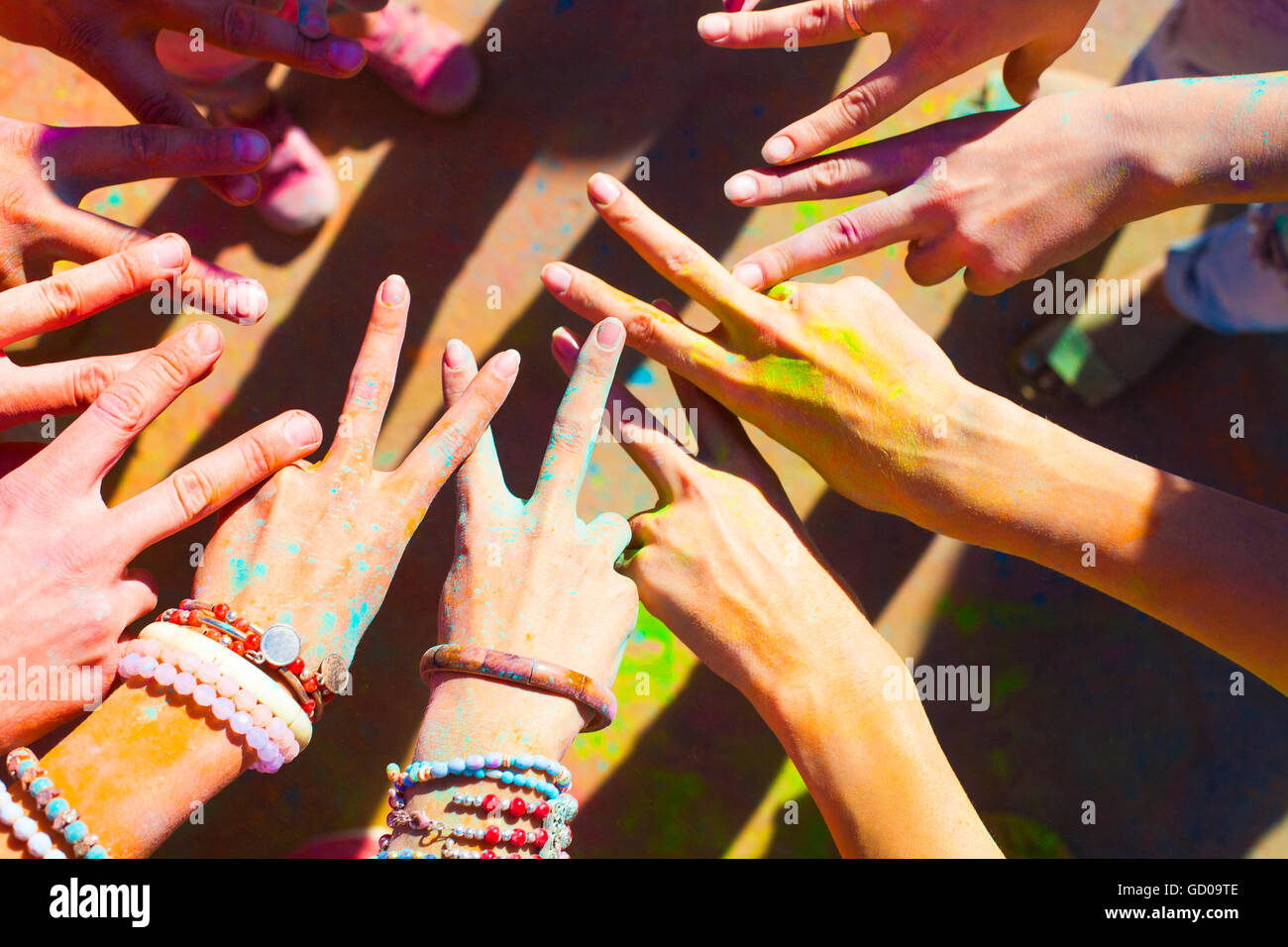 Friends putting their hands together in a sign of unity and teamwork ...