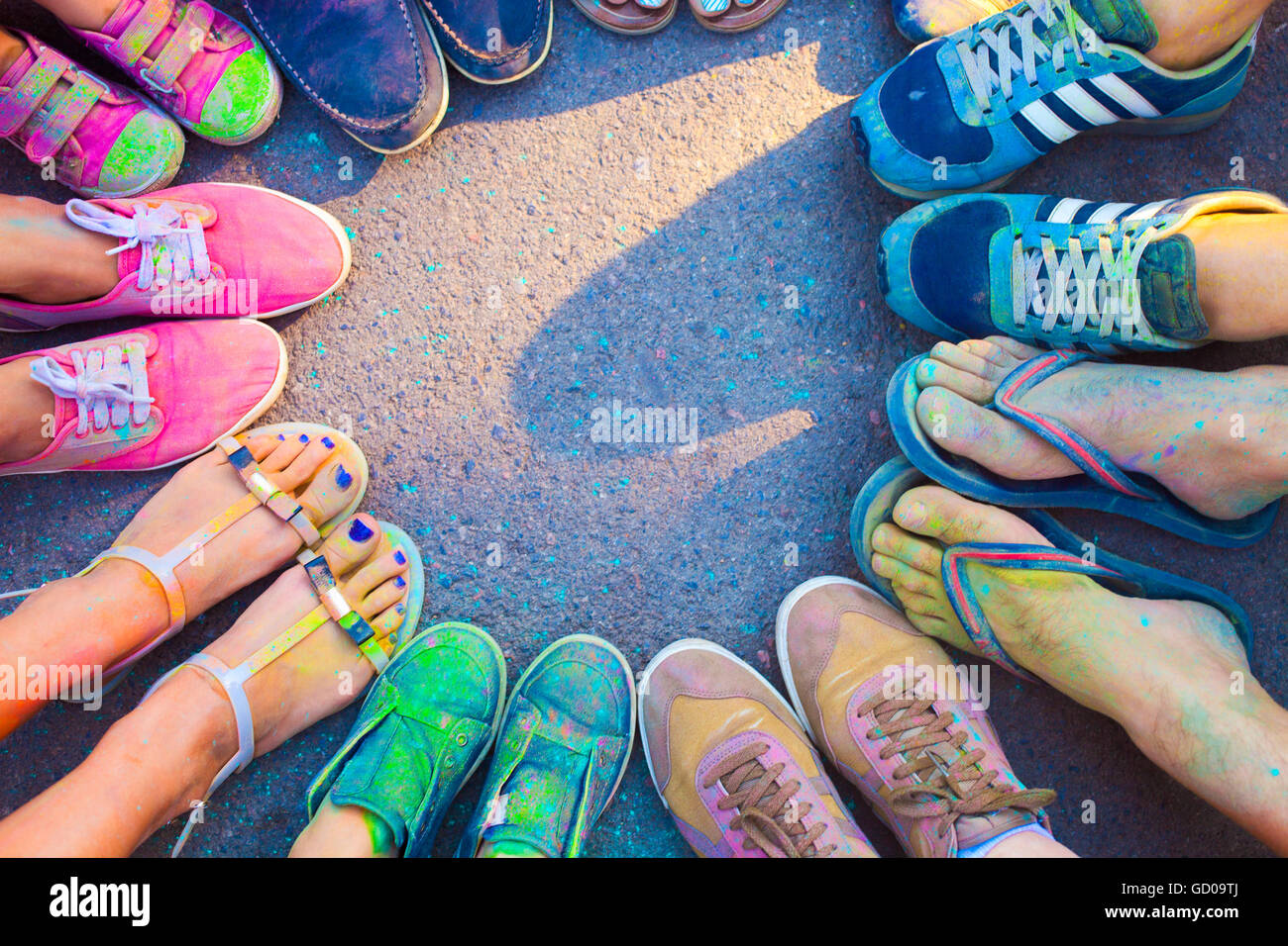 Friends putting their feet together in a sign of unity and teamwork ...