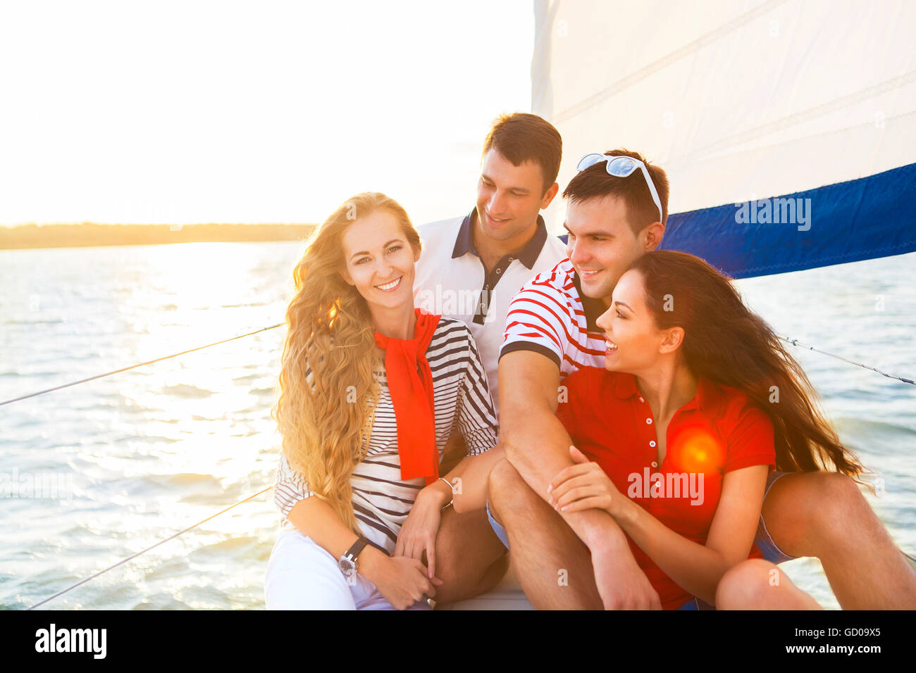 Smiling friends on yacht deck and greeting. Travel and vacation concept ...