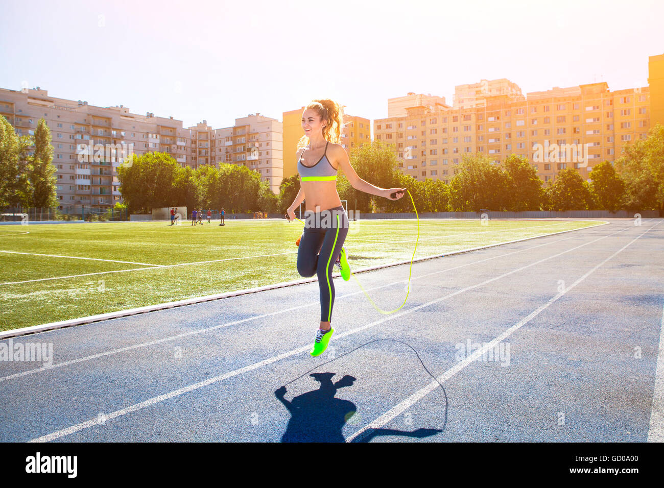 Woman with jumping rope. Beautiful young woman with a jumping rope in ...