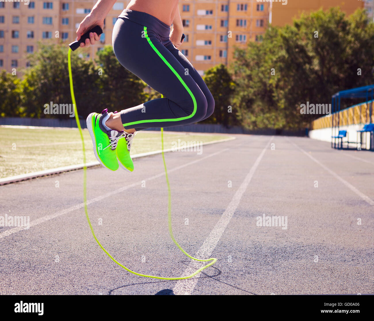 Woman with jumping rope. Beautiful young woman with a jumping rope in ...