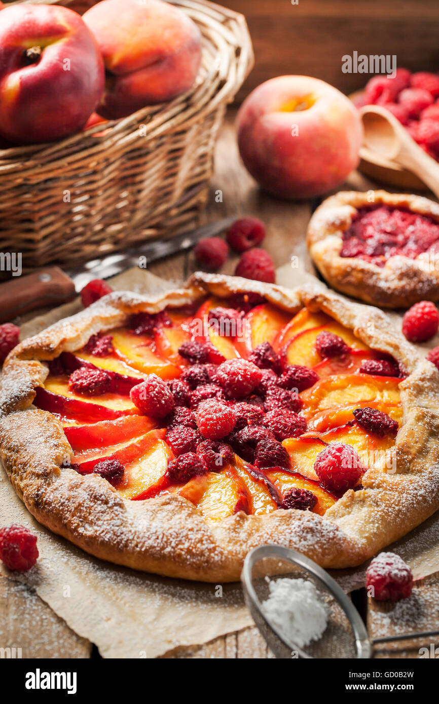 Rustic open pie with peach and raspberry (french galette Stock Photo ...