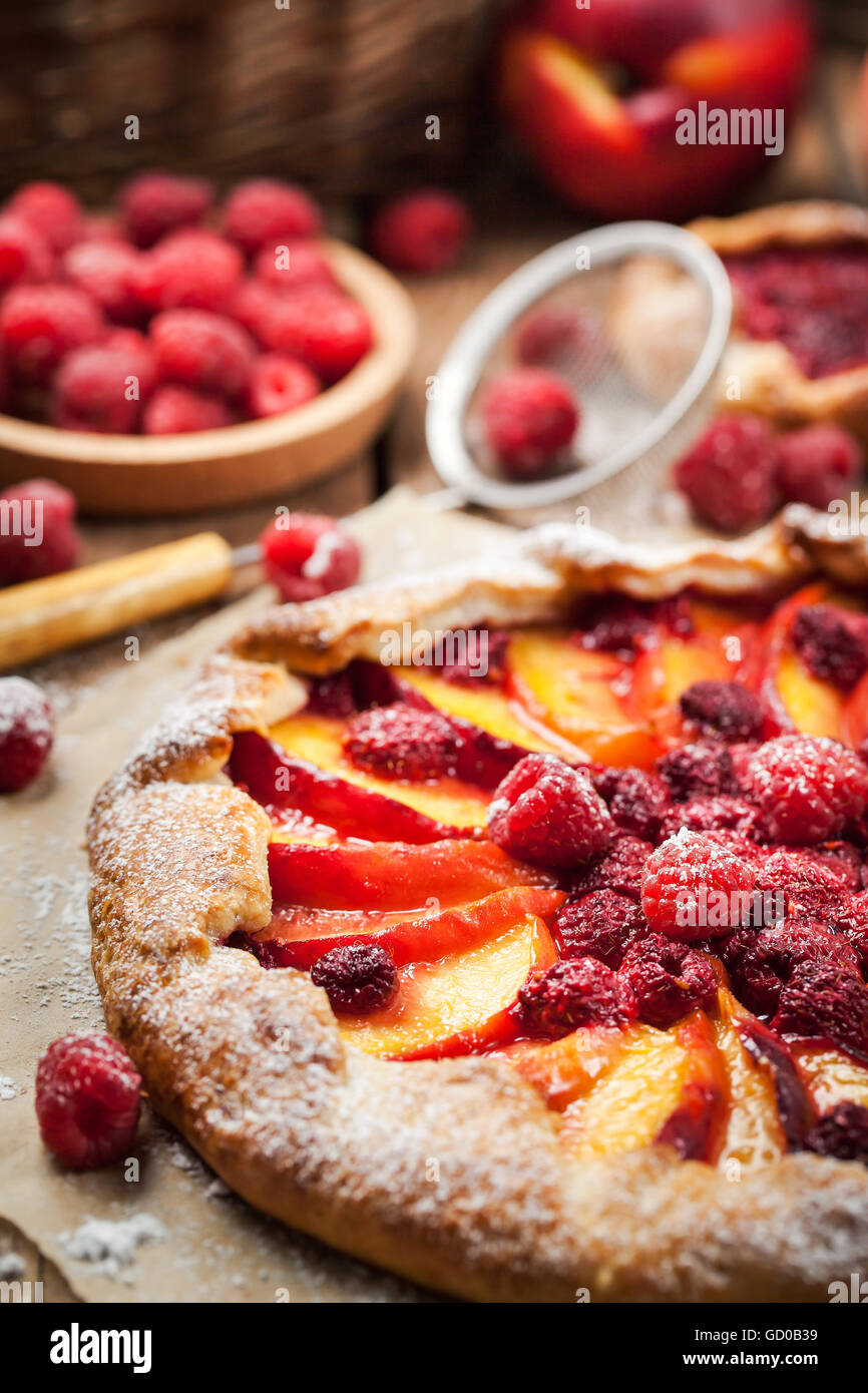 Rustic open pie with peach and raspberry (french galette Stock Photo ...