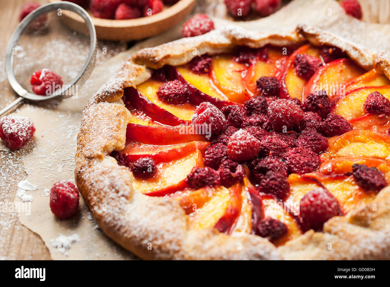 Rustic open pie with peach and raspberry (french galette Stock Photo ...