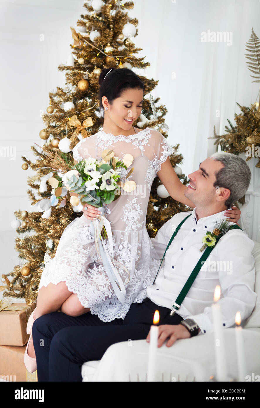 Cheerful happy married couple by Christmas decorations Stock Photo - Alamy