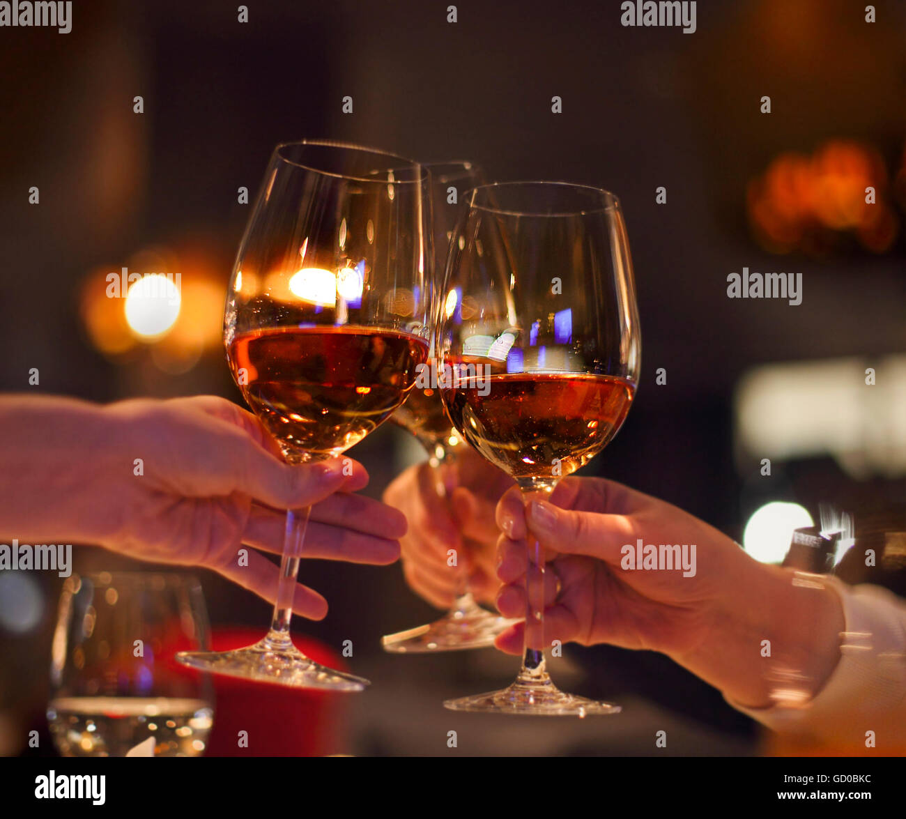 Toast in restaurant with full glasses of rose wine. Celebration concept ...