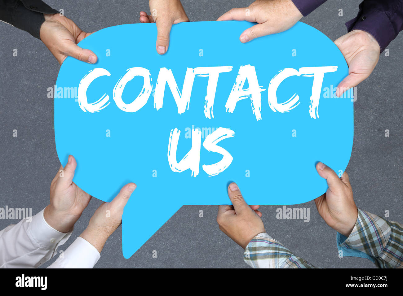 Group of people holding with hands the word contact us assistance ...