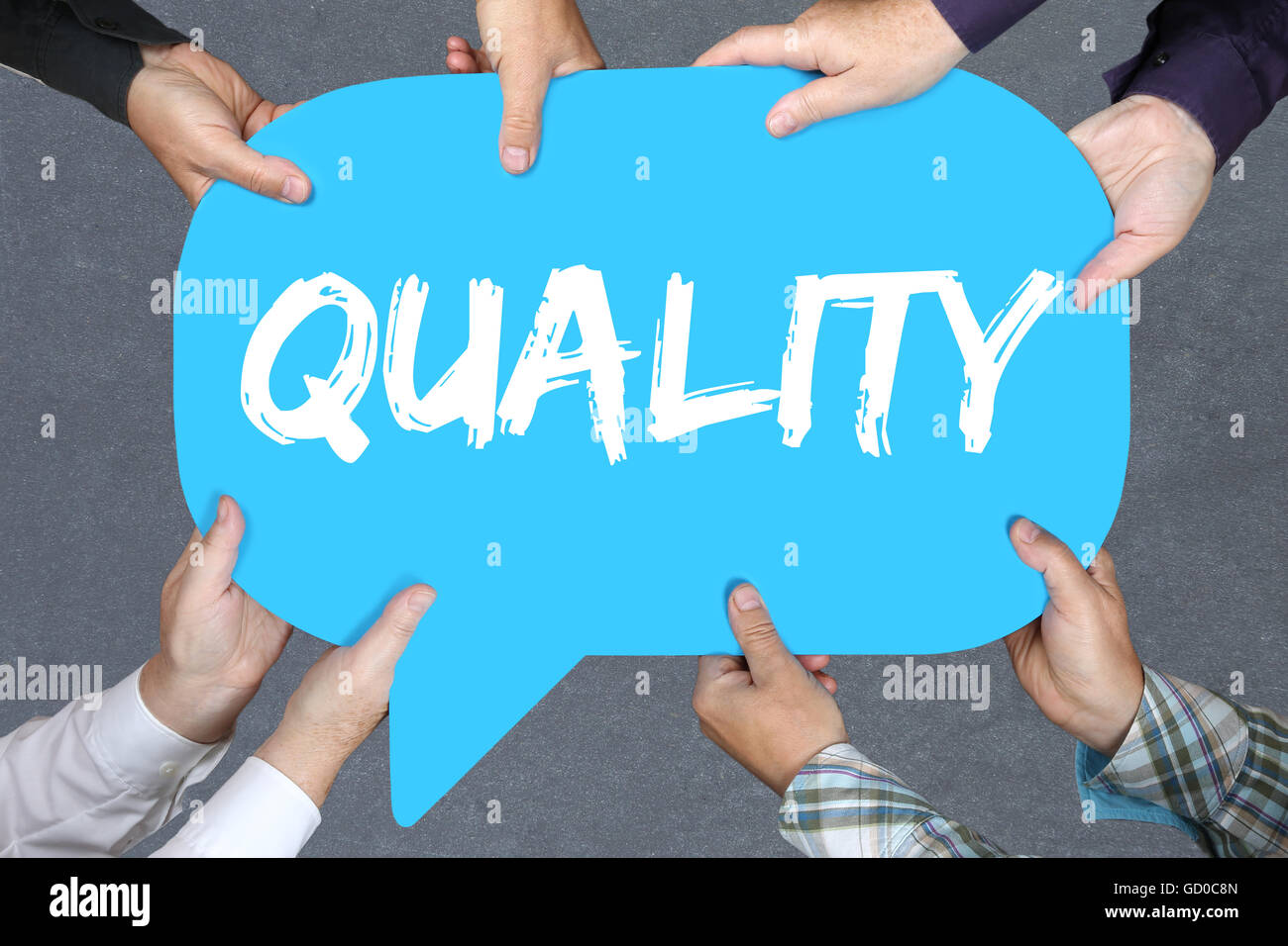 Group of people holding with hands the word Quality control management ...
