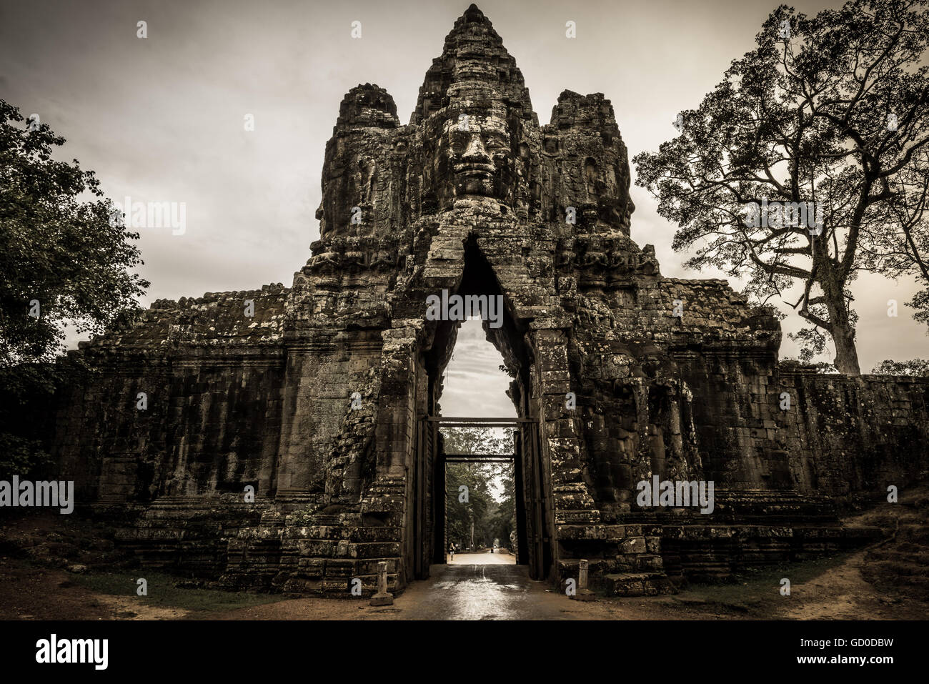 The ancient and crumbling entrance to the Angkor Thom region in Siem ...