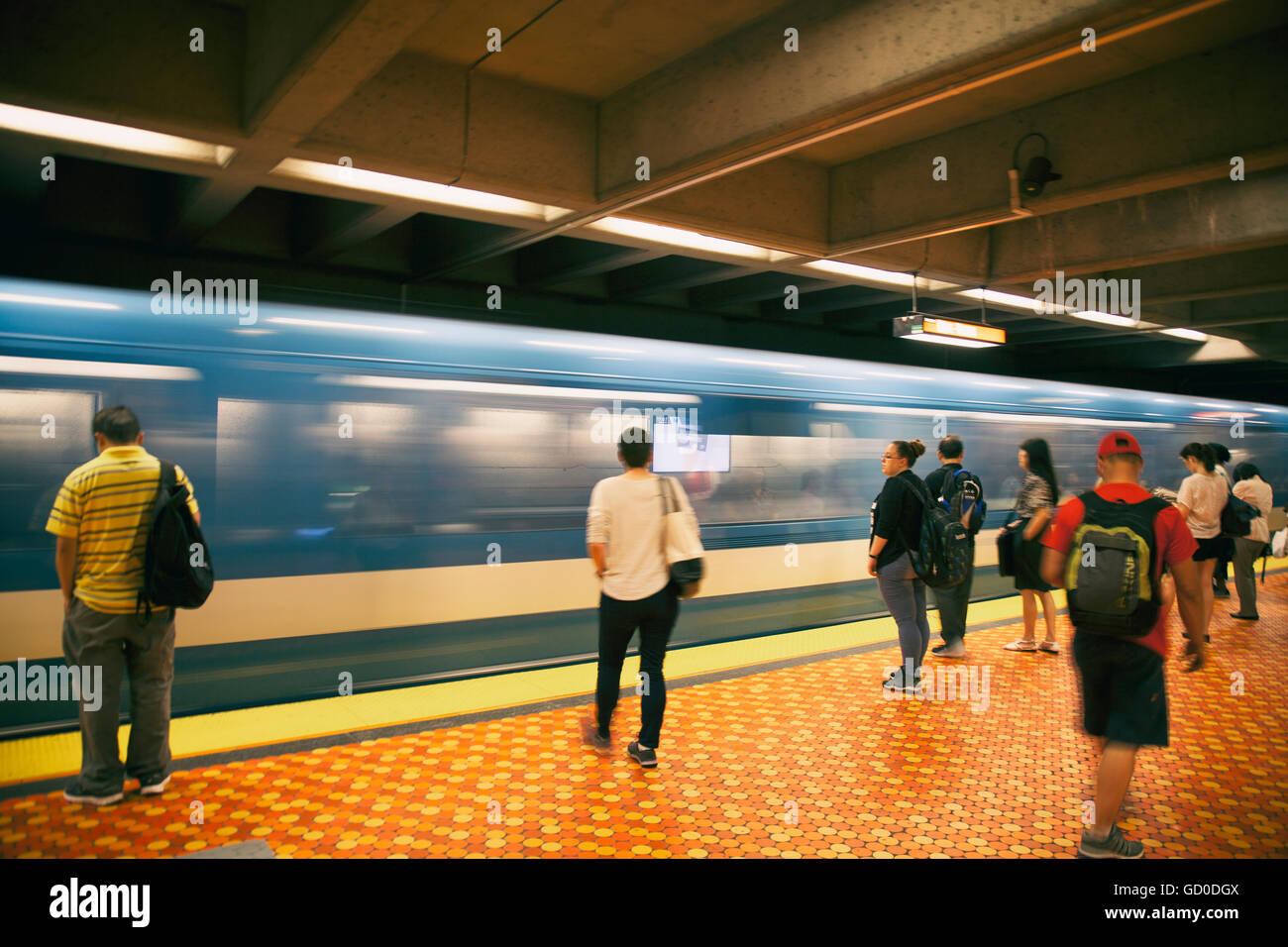 commuters on subway platform as train speeds by Stock Photo - Alamy