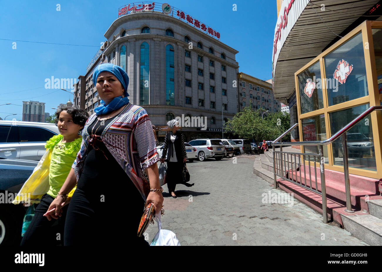 Uygur women walking on Urumqi street Stock Photo - Alamy