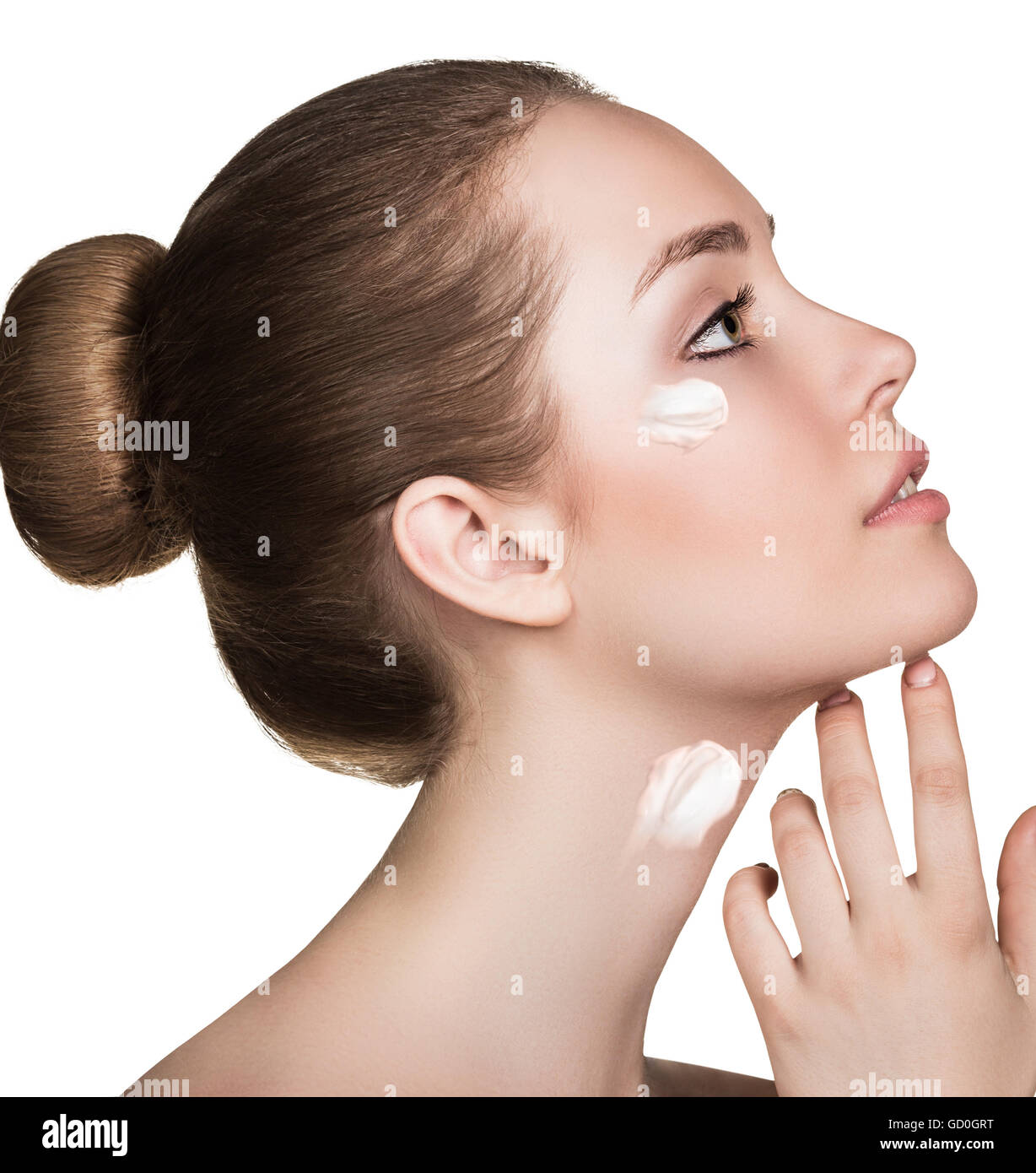 Beautiful model applying cream on face Stock Photo - Alamy