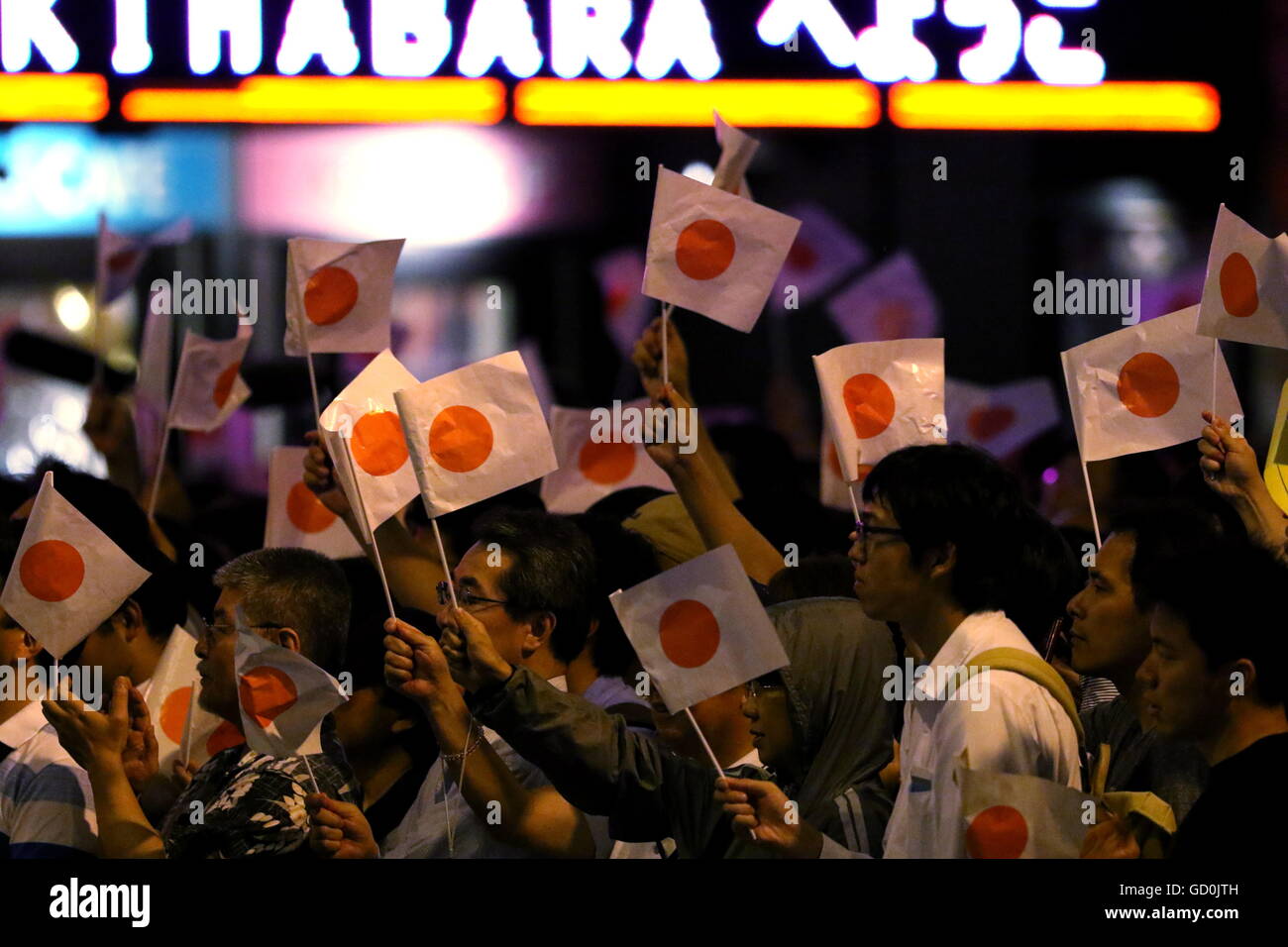 People wave Japanese national flags as Japanese Prime Minister and ...