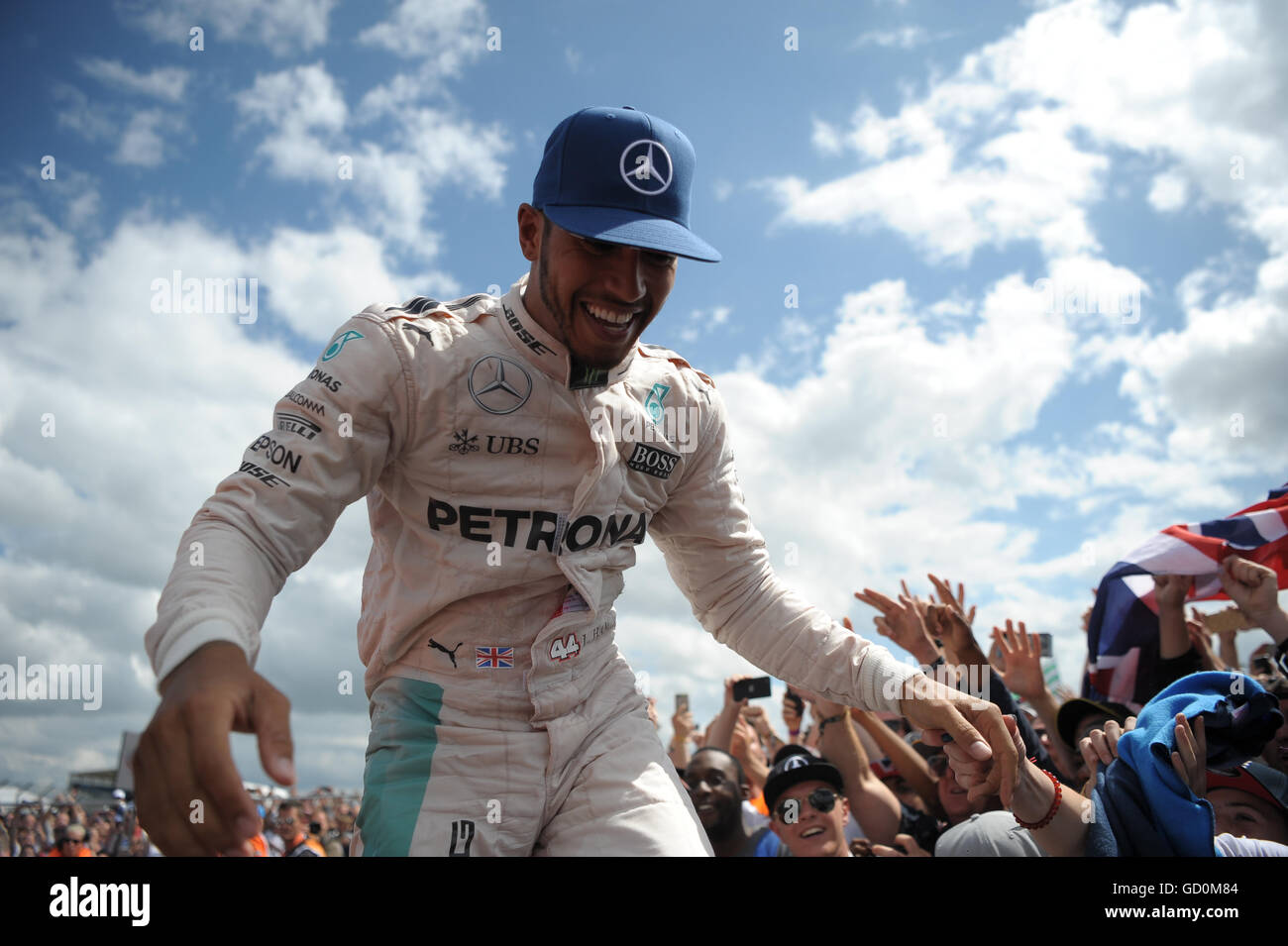 Silverstone, UK. 10th July, 2016. Lewis Hamilton does a crowd surf ...
