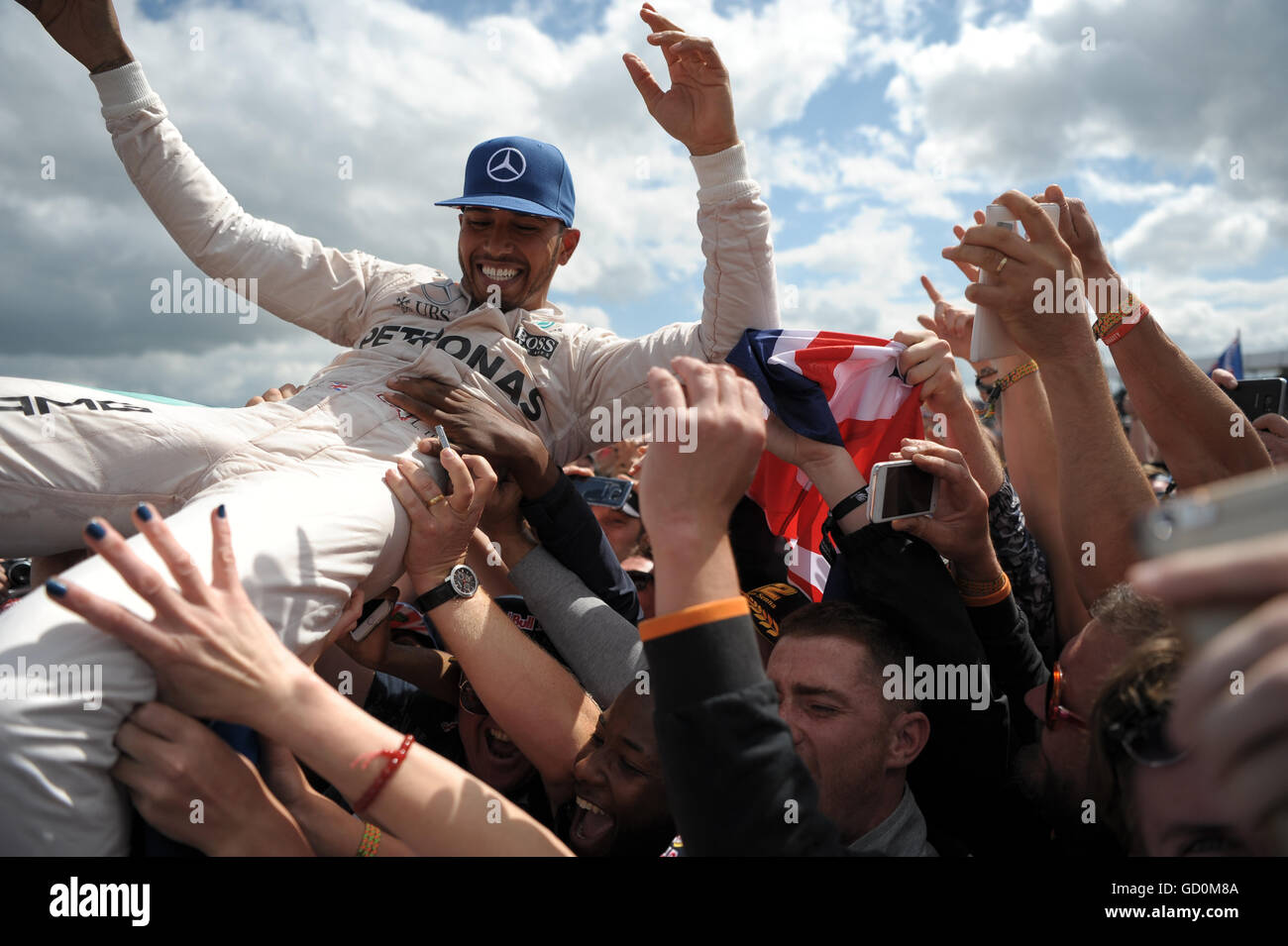 Silverstone, UK. 10th July, 2016. Lewis Hamilton does a crowd surf ...