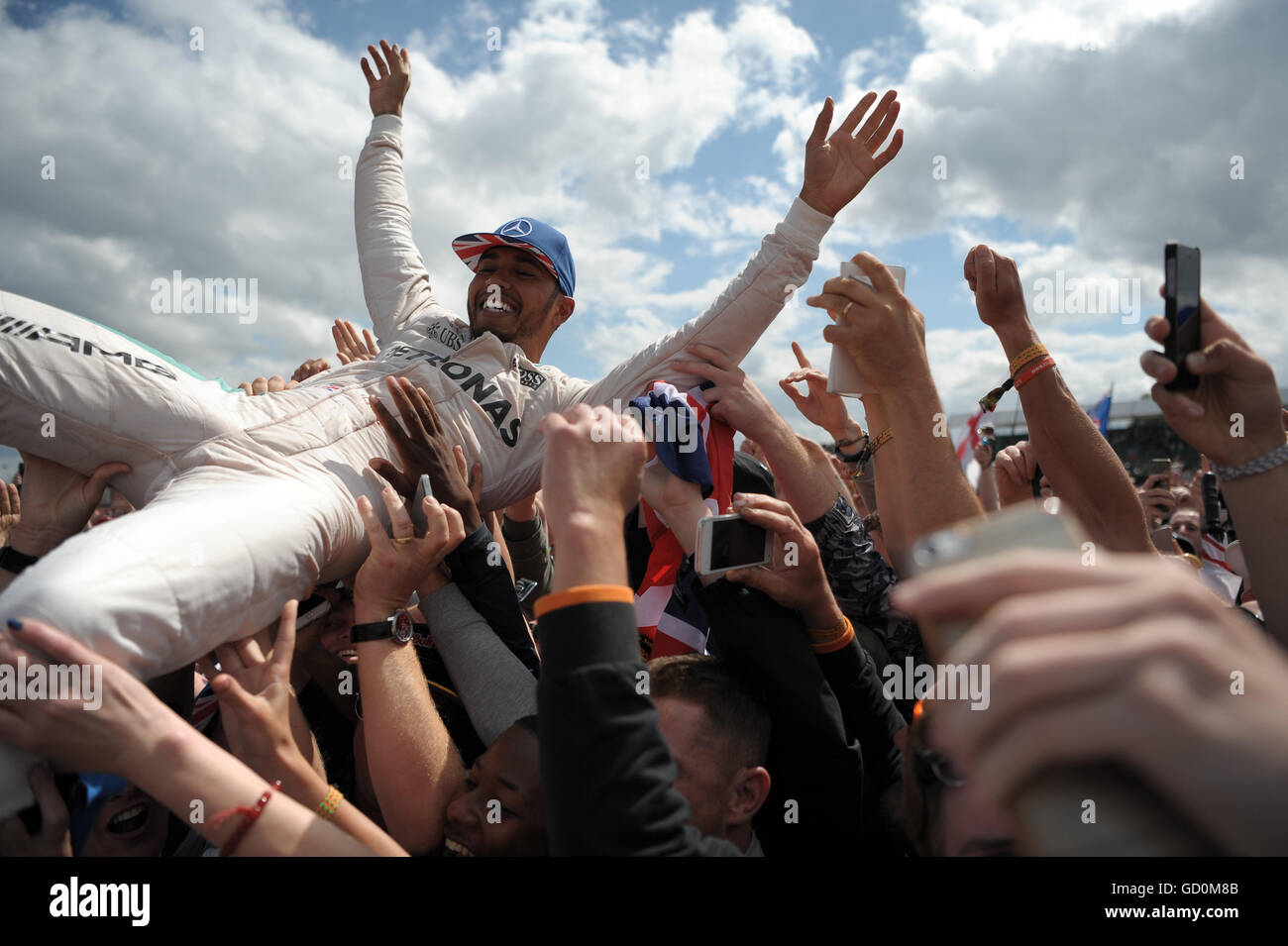 Silverstone, UK. 10th July, 2016. Lewis Hamilton does a crowd surf ...
