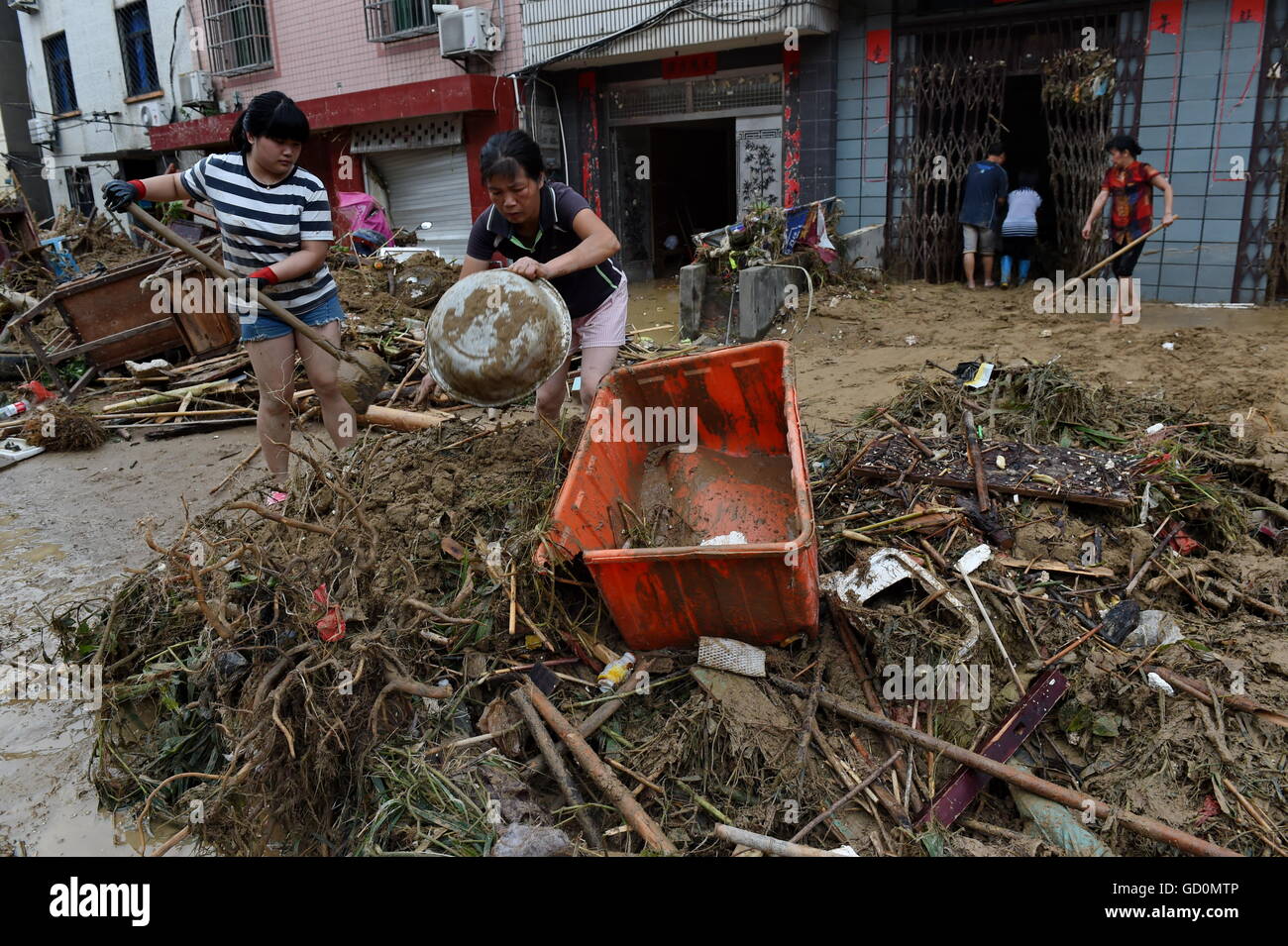 Minqing, China's Fujian Province. 10th July, 2016. Residents clear ...