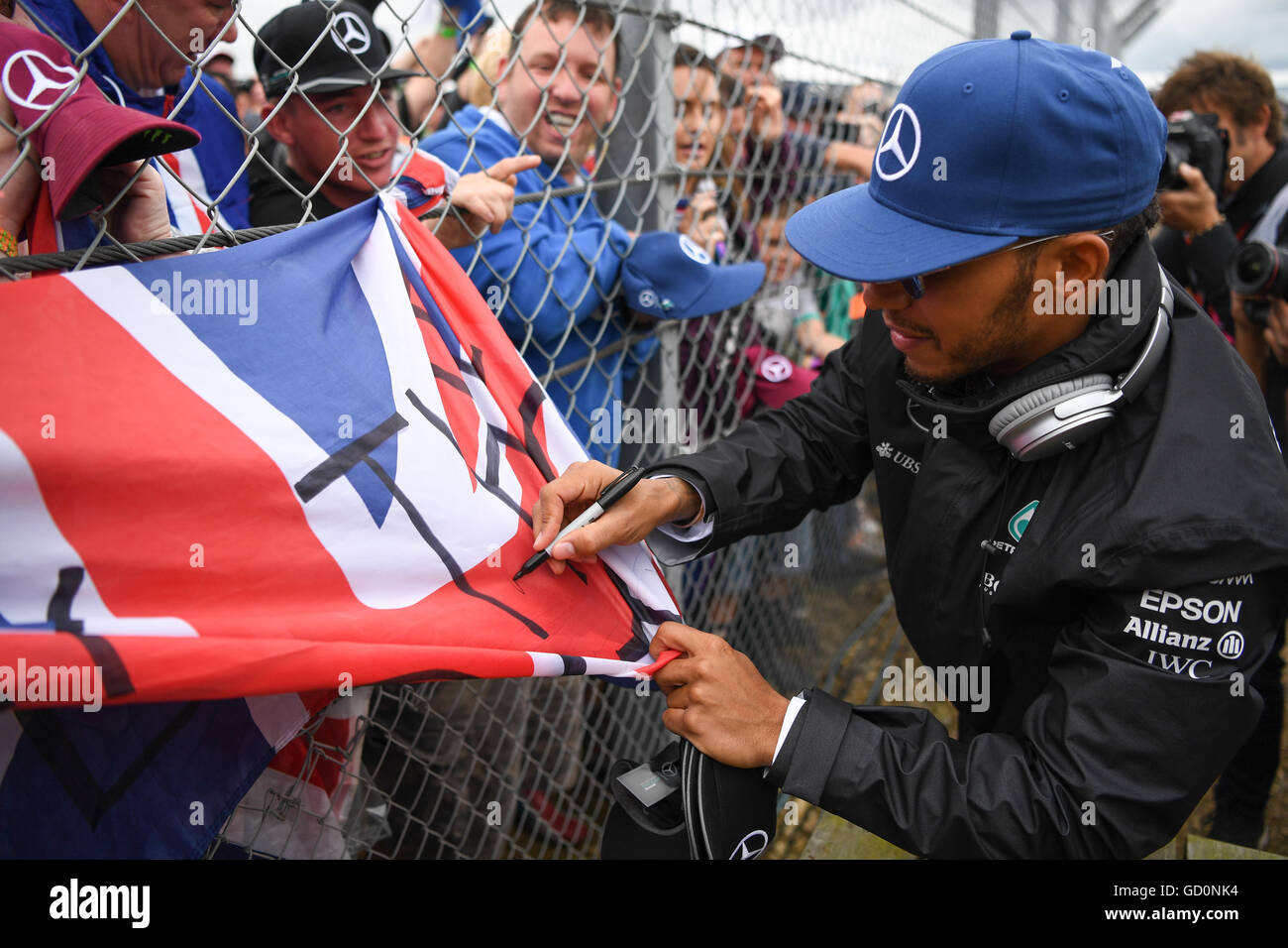 Silverstone, UK. 10th July, 2016. Lewis Hamilton signs autographs for ...