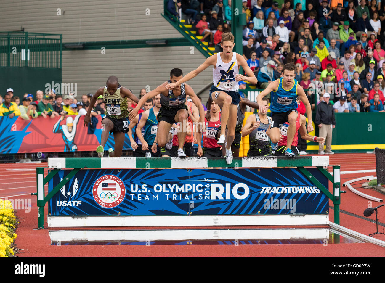 Eugene, USA. 8th July, 2016. Runners come over the water obstacle ...