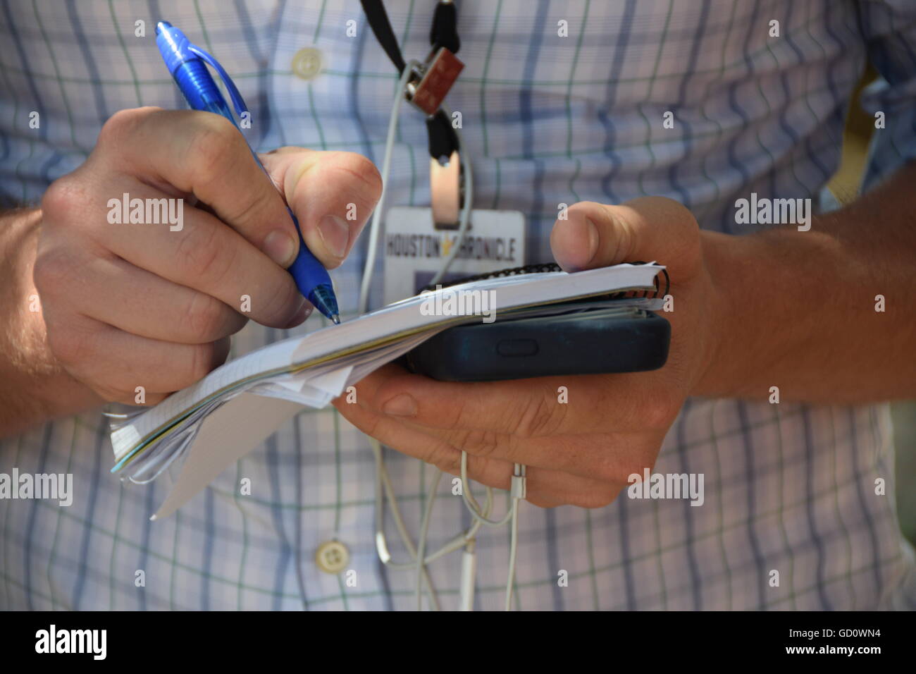 A Houston Chronicle reporter taking notes during an interview at Police ...
