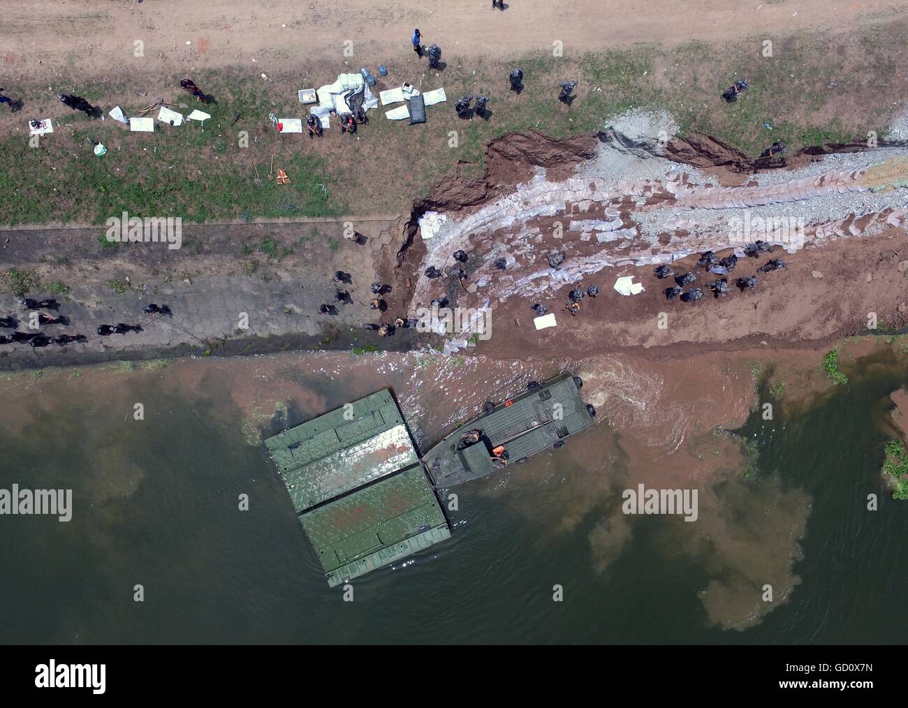 Huarong, China's Hunan Province. 11th July, 2016. Rescuers try to ...