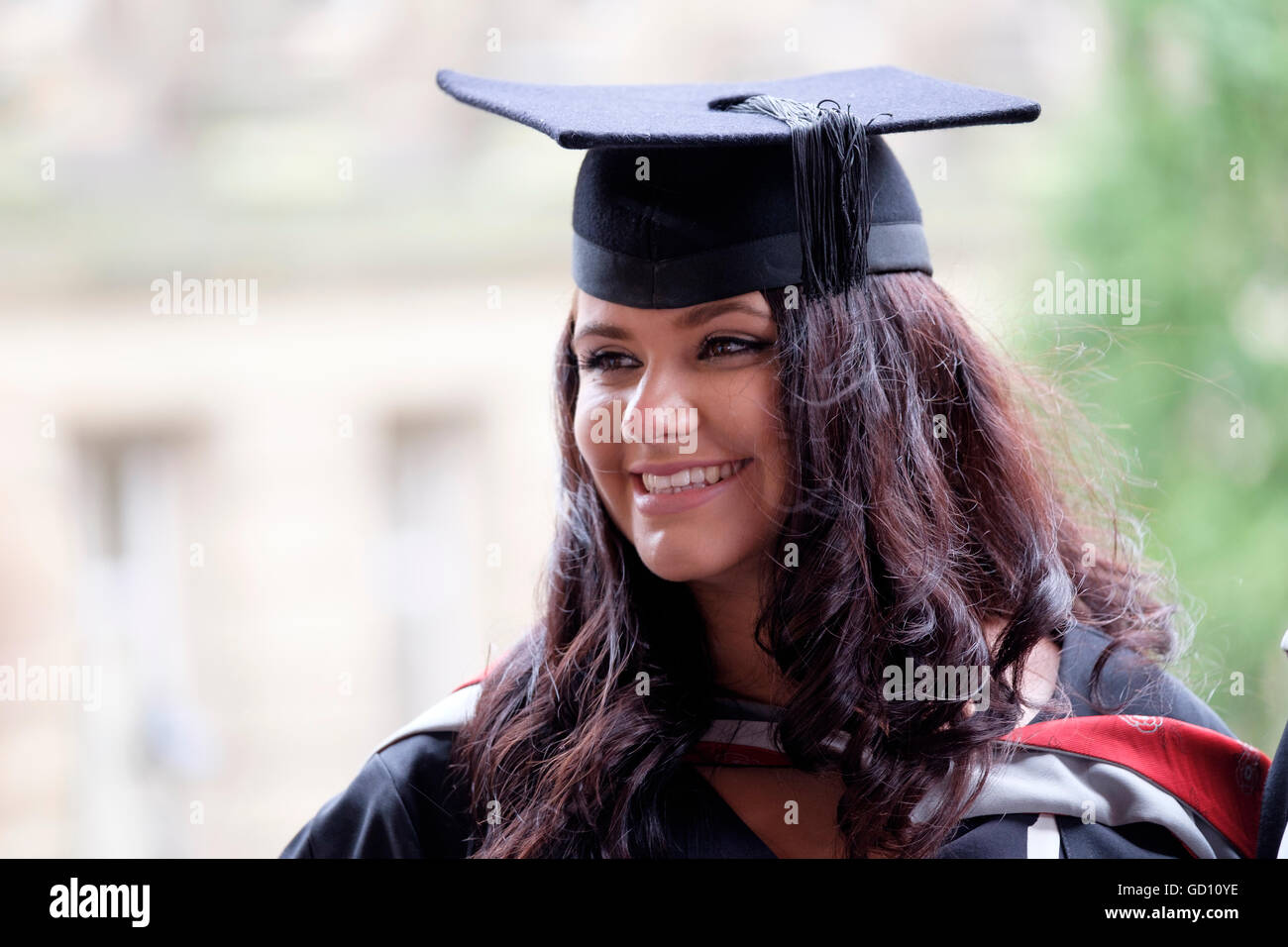 Happy, smiling attractive female student celebrating on graduation day ...