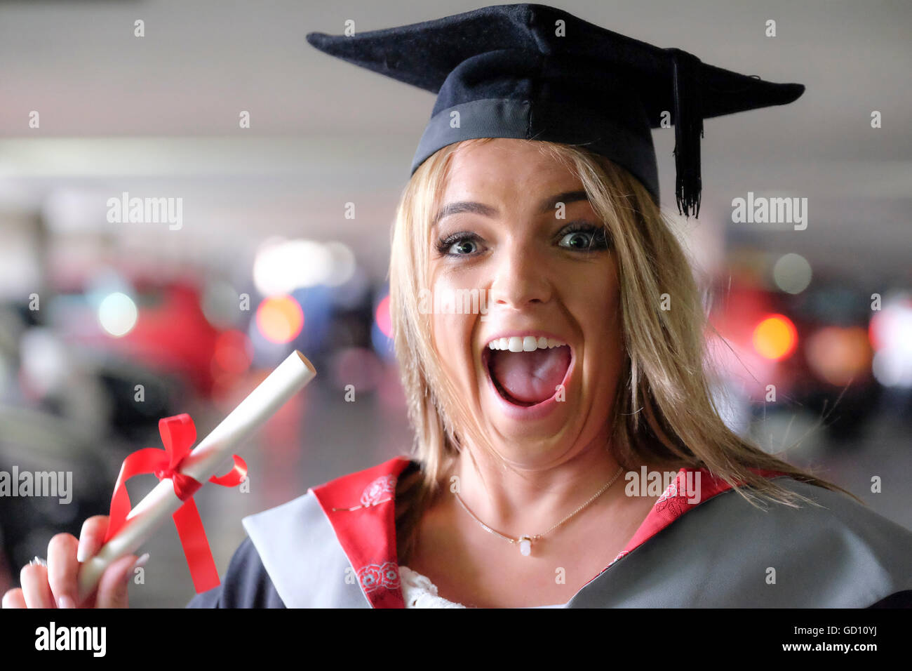 Happy, smiling, female student celebrates on graduation day Stock Photo ...