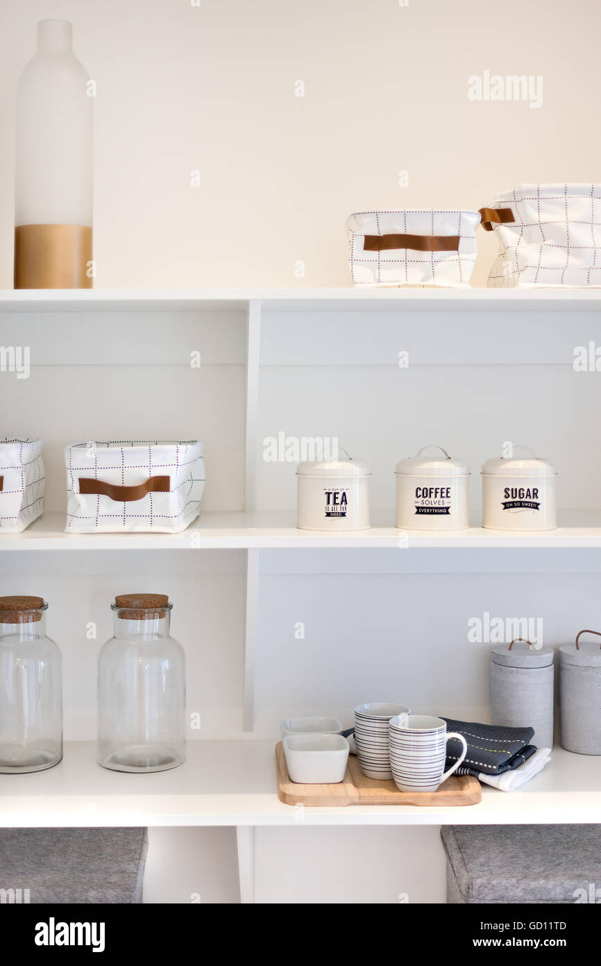 Natural kitchenware in a white wooden shelf, including see through ...