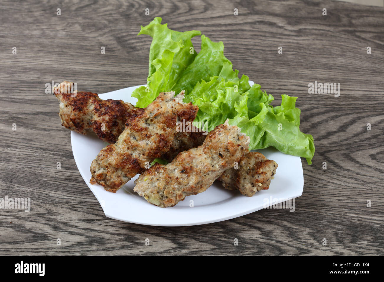 Meat kebab with green salad leaves Stock Photo - Alamy