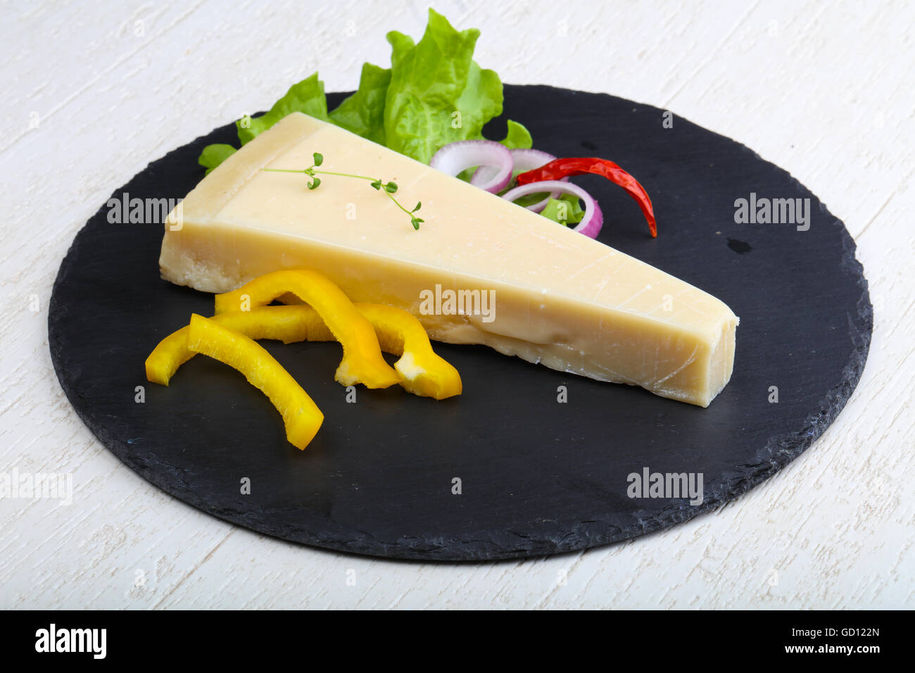 Parmesan cheese triangle on the wood background Stock Photo - Alamy