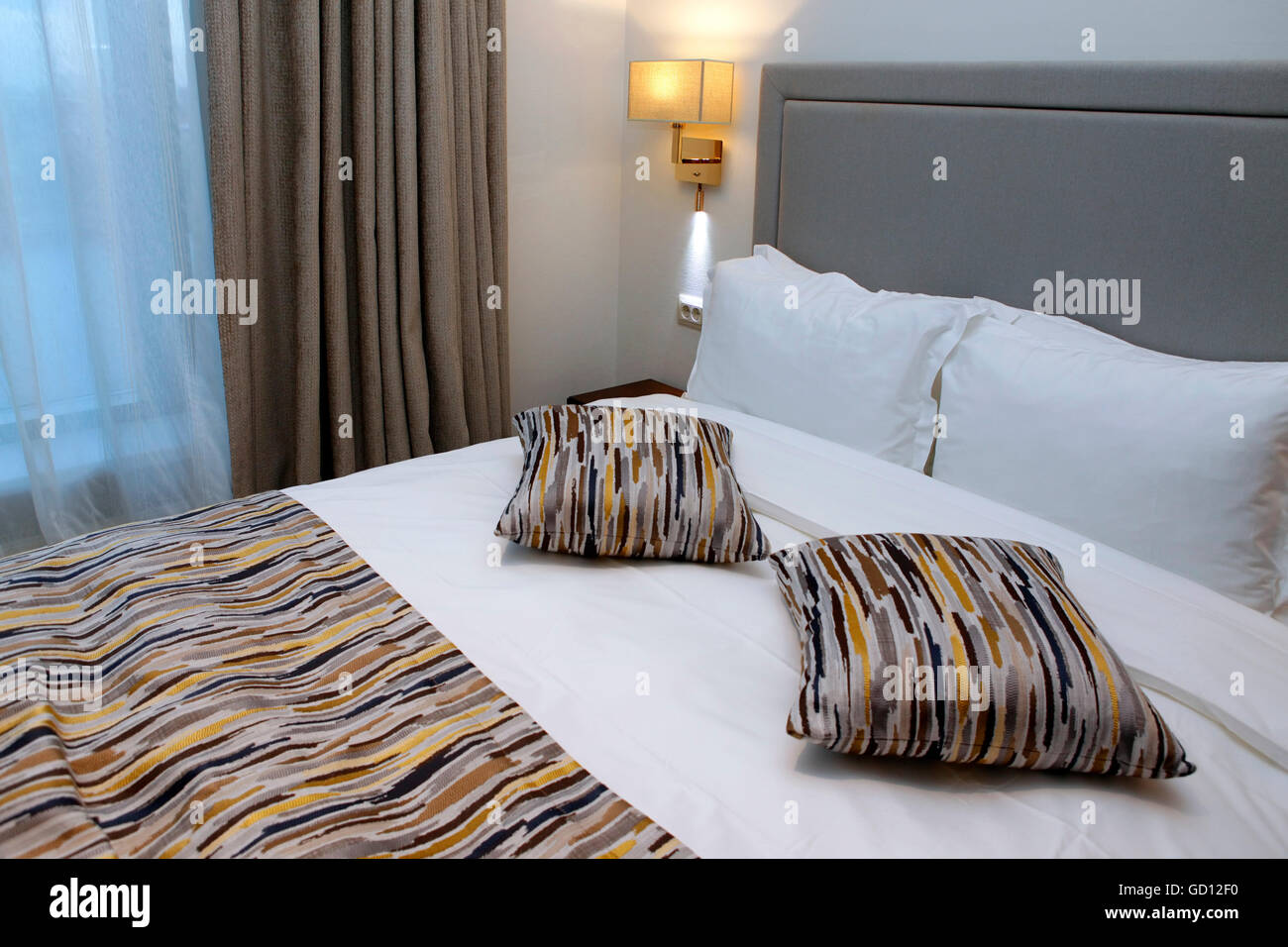 Nice bedroom with the big bed Stock Photo - Alamy