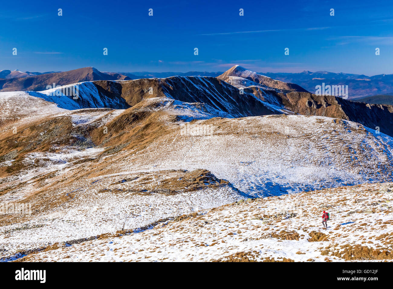 Hiker walking on Snow Slope Trail Mountains View Stock Photo - Alamy