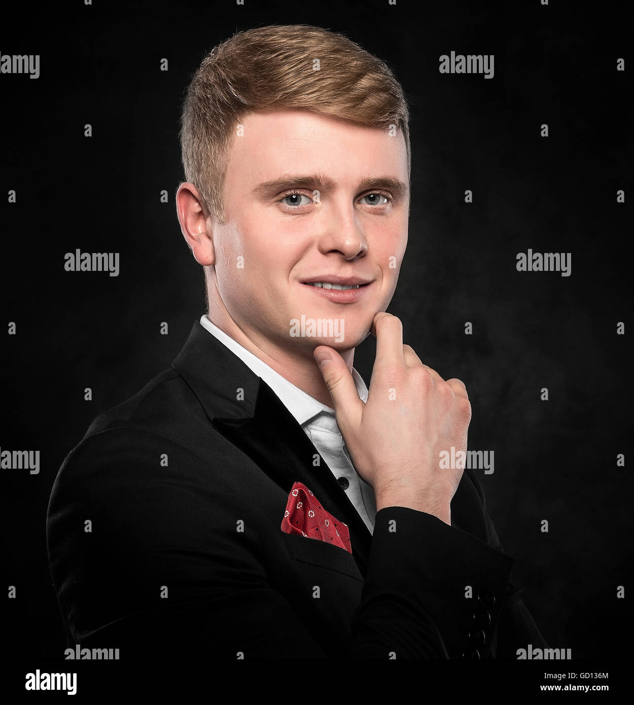 Young handsome man in suit on dark background Stock Photo - Alamy