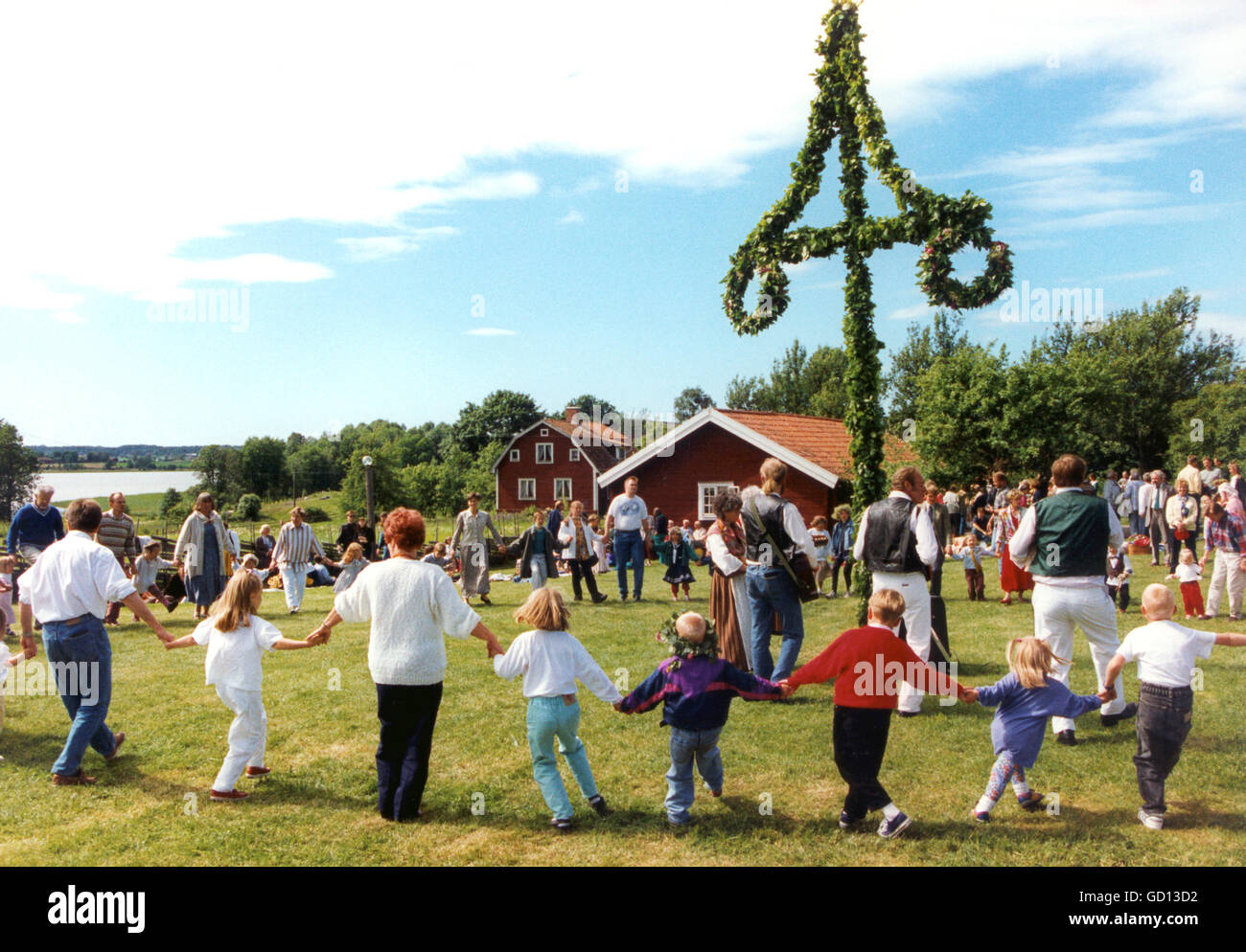Midsummer with dancing and games around the maypole Stock Photo - Alamy