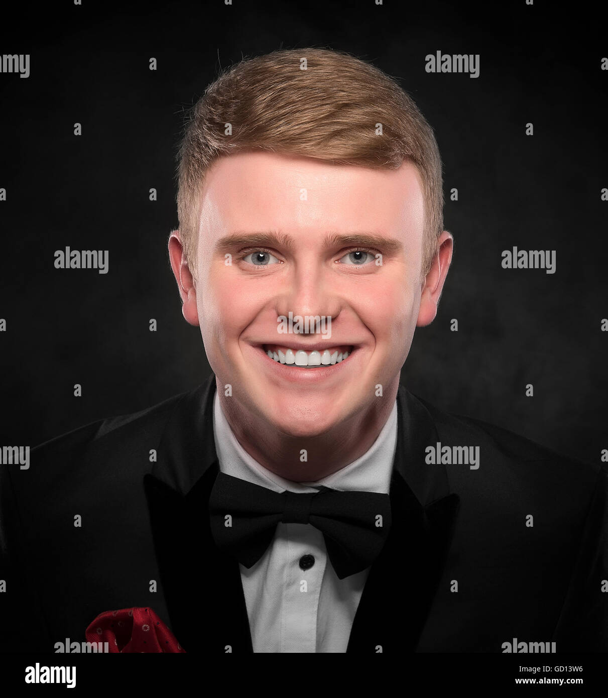 Young handsome man in suit with bow-tie smiling on dark background ...