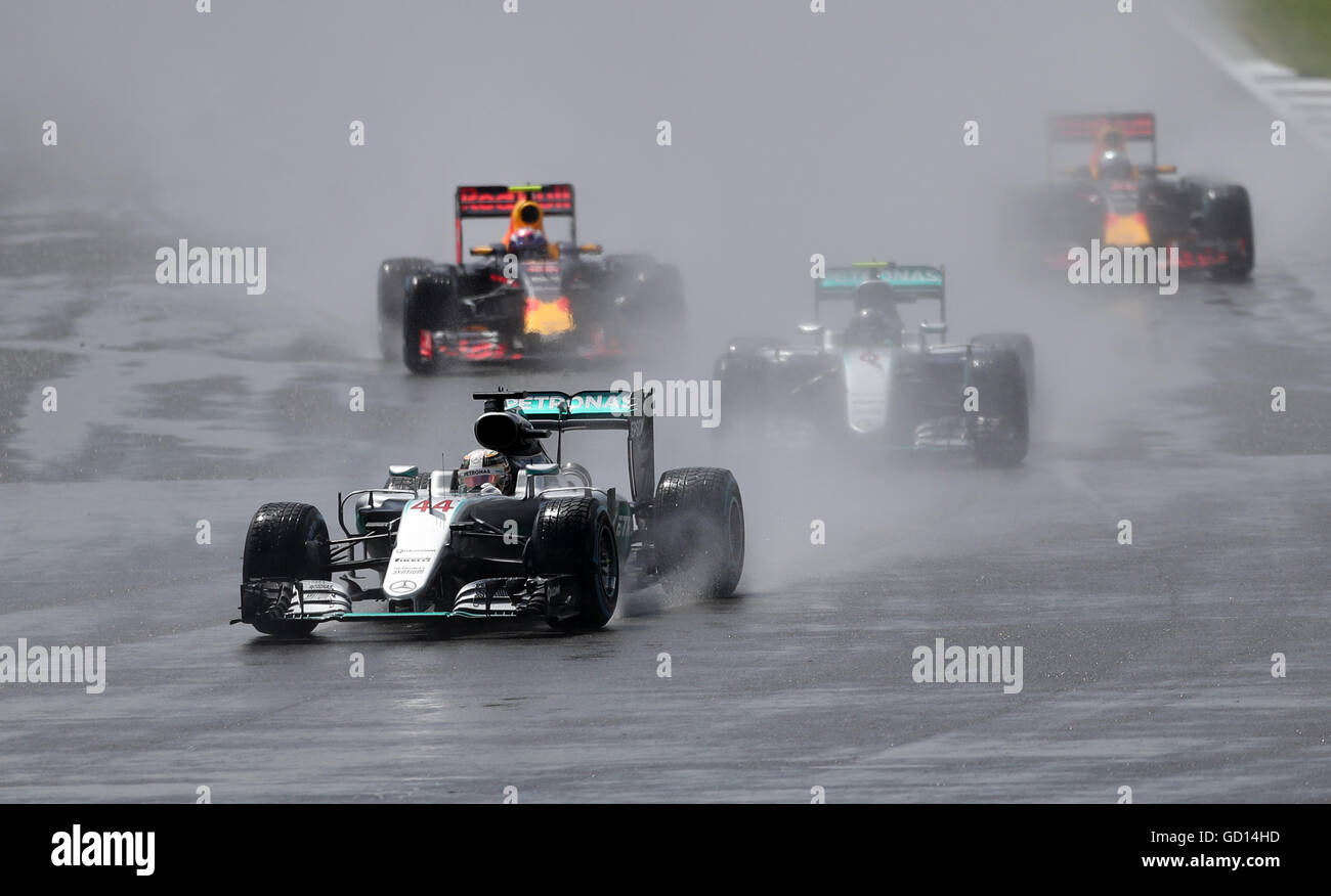 Mercedes' Lewis Hamilton (left) goes into the first corner after the a ...