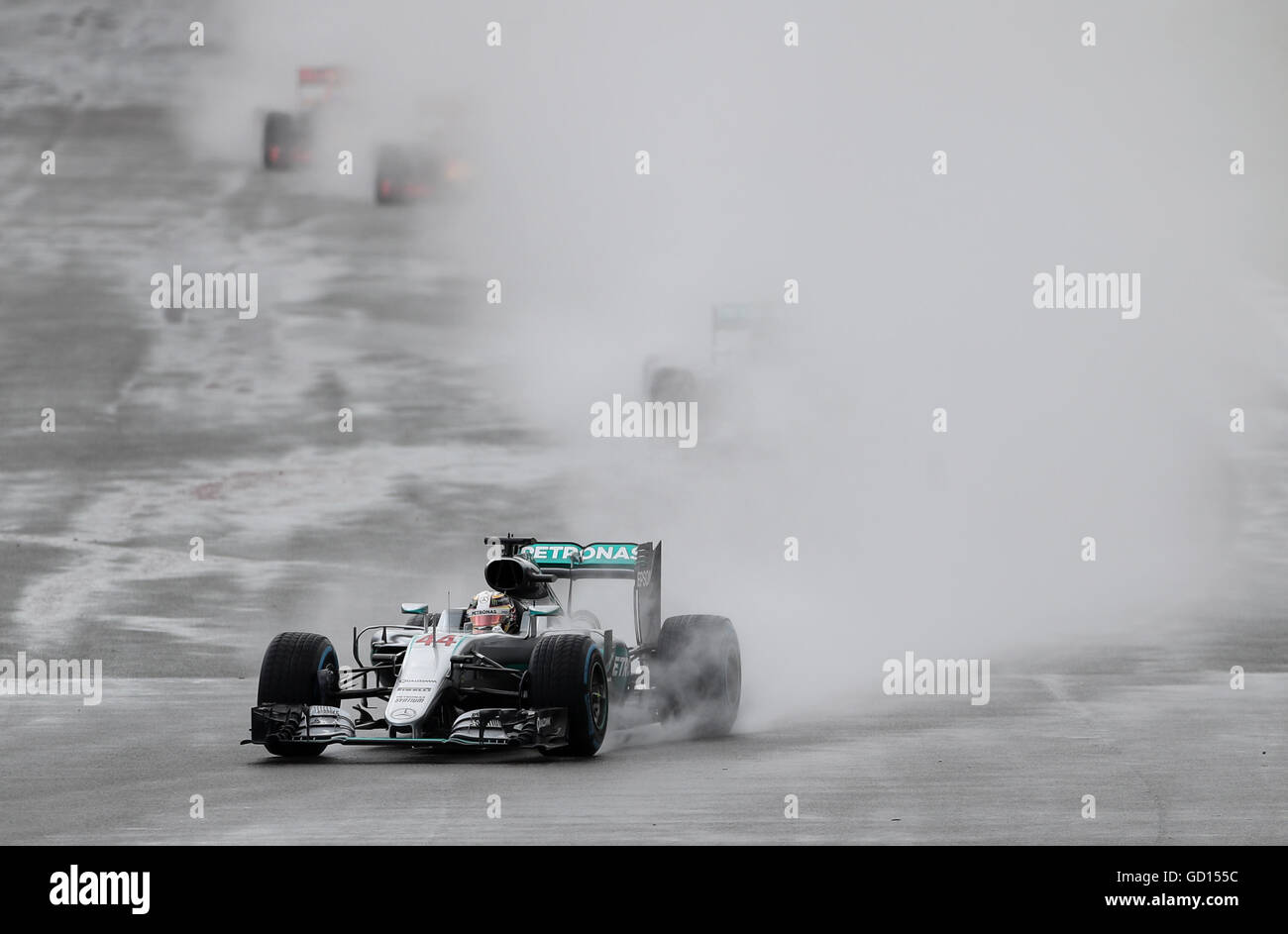 Mercedes' Lewis Hamilton (left) goes into the first corner after the a ...