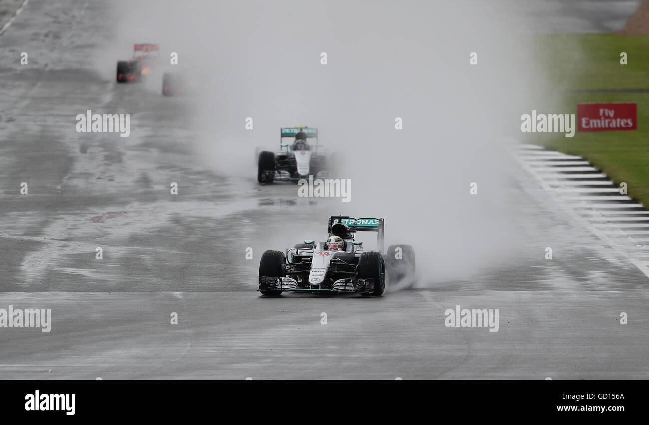 Mercedes' Lewis Hamilton (left) goes into the first corner after the a ...