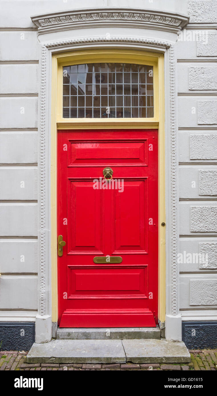 Classic red door in a white wall Stock Photo - Alamy