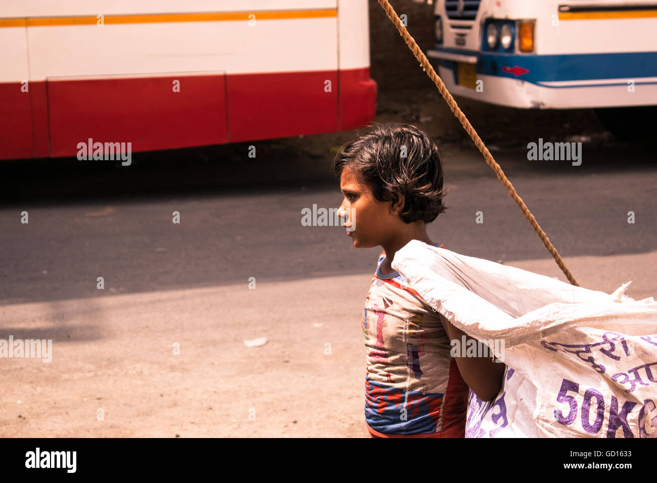 Young girl rag picker collecting scrap from garbage Stock Photo - Alamy