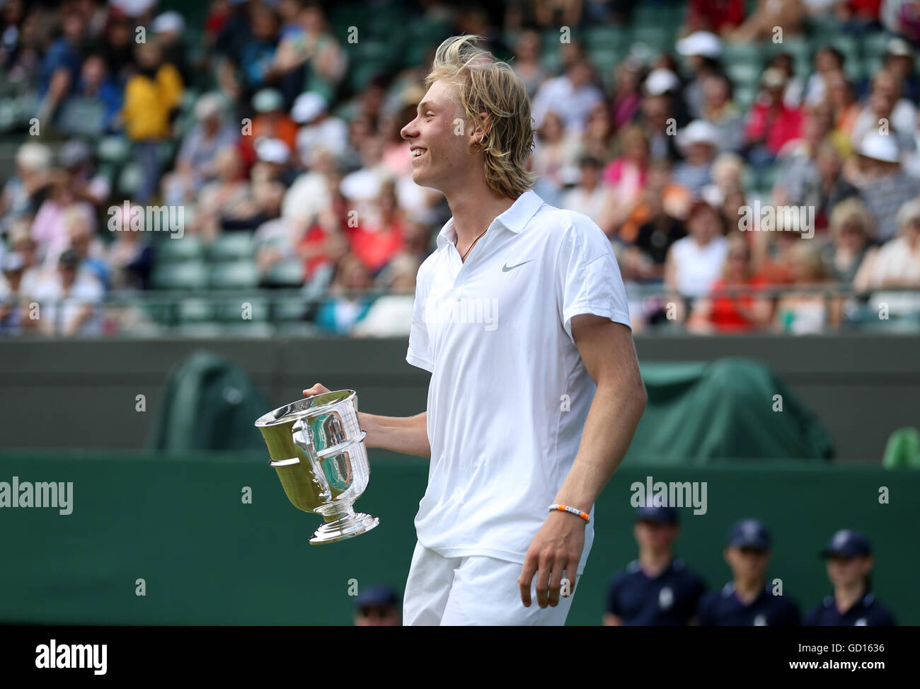 Denis Shapovalov holds his trophy after winning the Boys Singles on day ...