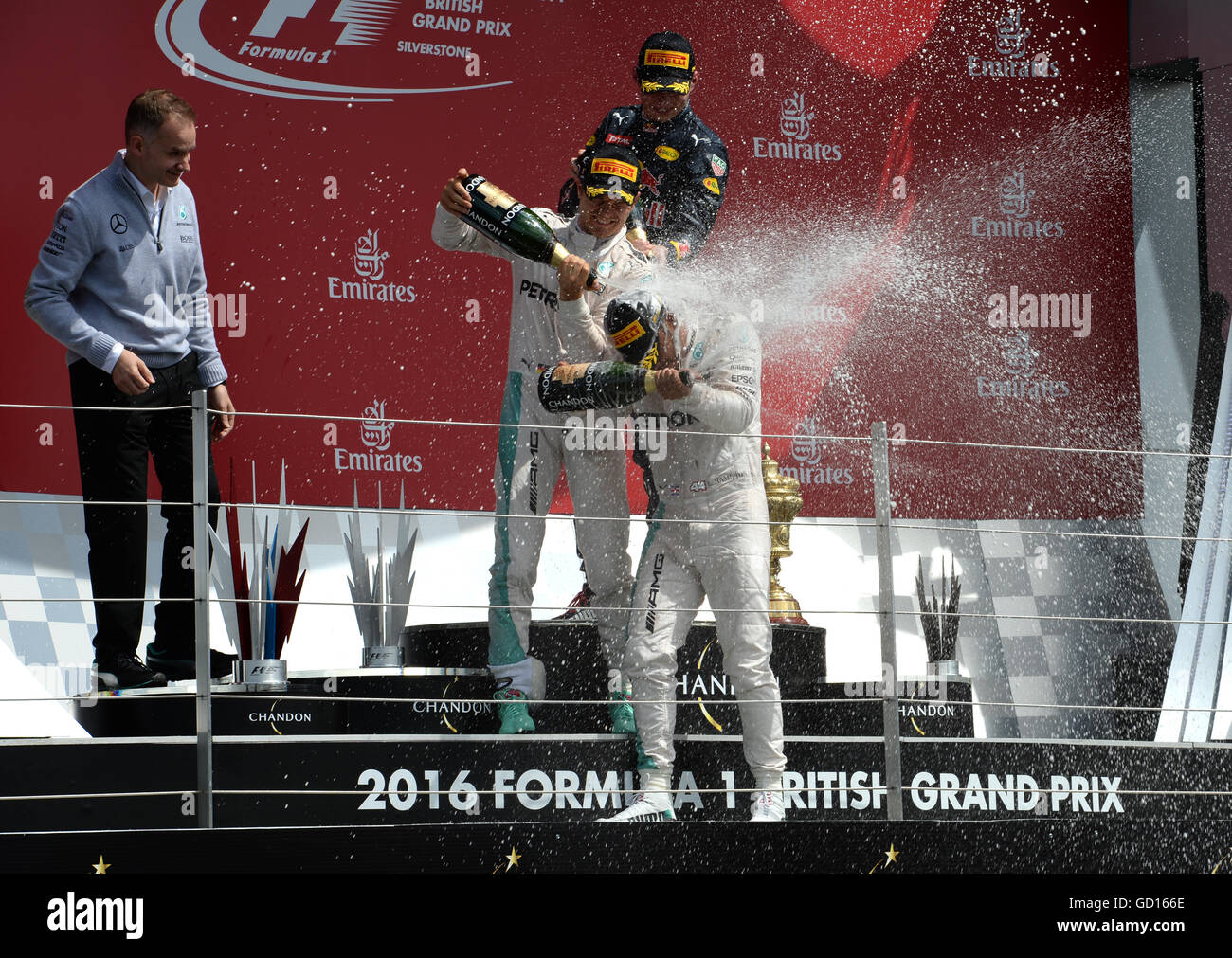 British GP winner Mercedes' Lewis Hamilton is sprayed with champange by ...